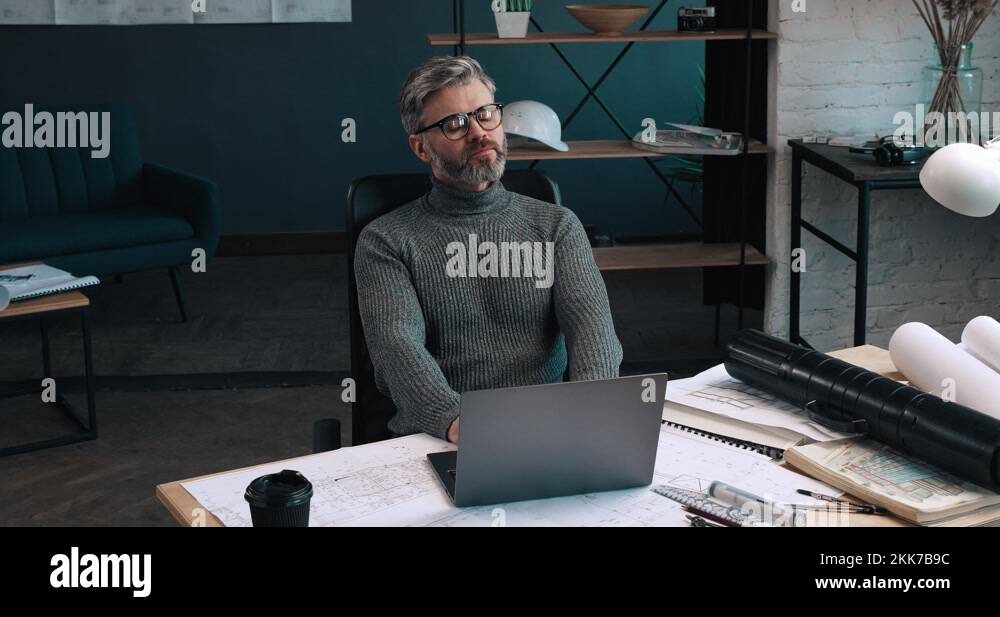 Handsome middle Aged man working at his Modern Office, sitting at the ...
