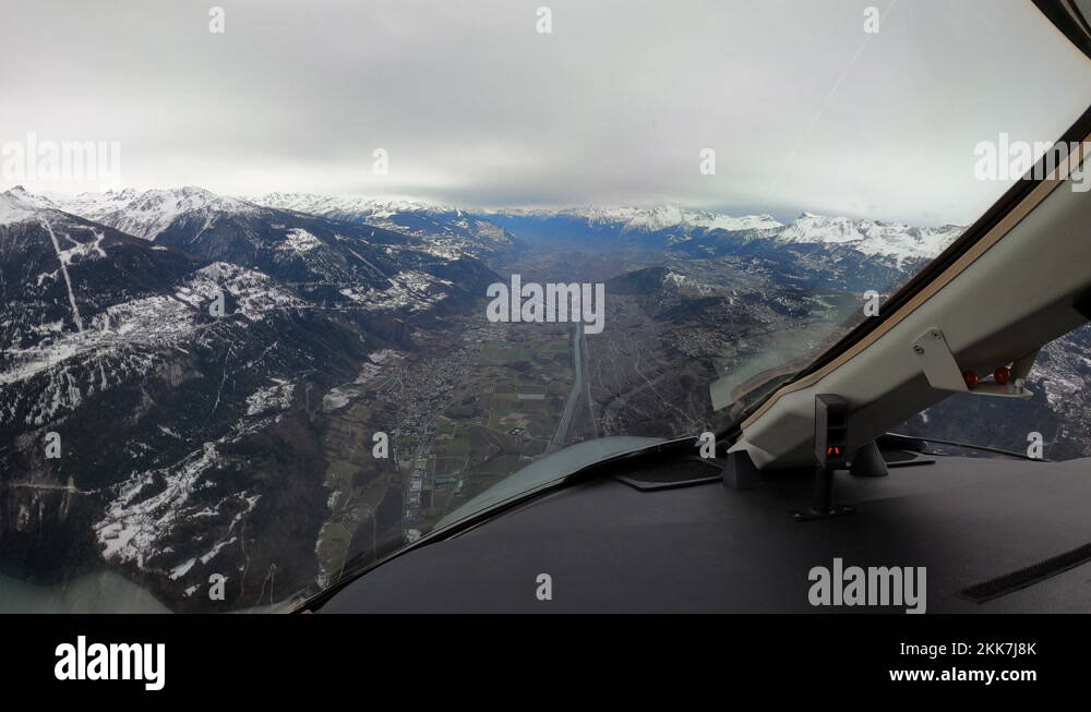 Airplane cockpit view of landing approach through Sion Valley mountains ...