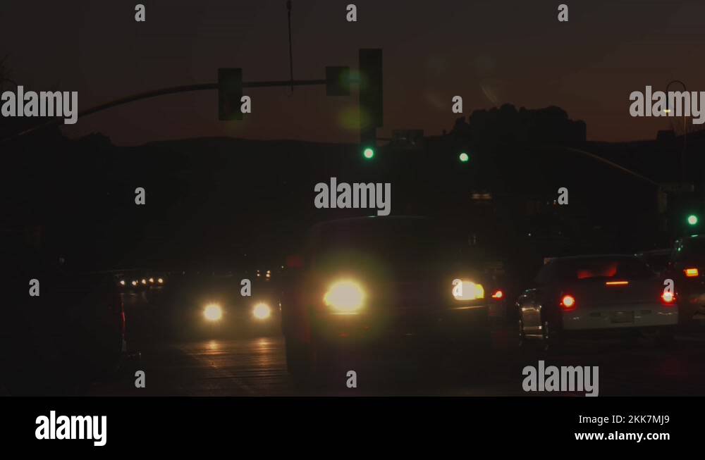 Incoming night traffic, with car headlights illuminating the main city ...