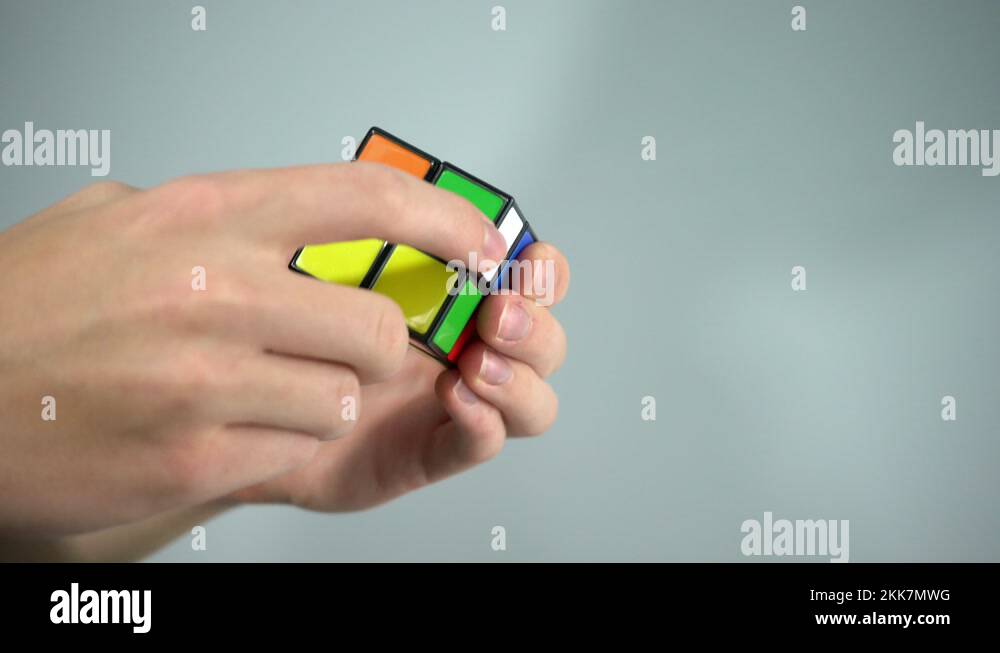 Solving Rubik's cube with hands in studio shot with white background 4k Stock Video Footage - Alamy