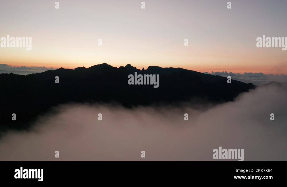 Epic silhouette scenery of mountain in Madeira flying backwards into ...