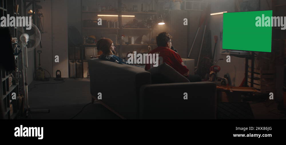 GREEN SCREEN CHROMA KEY Back view two friends playing video game inside ...