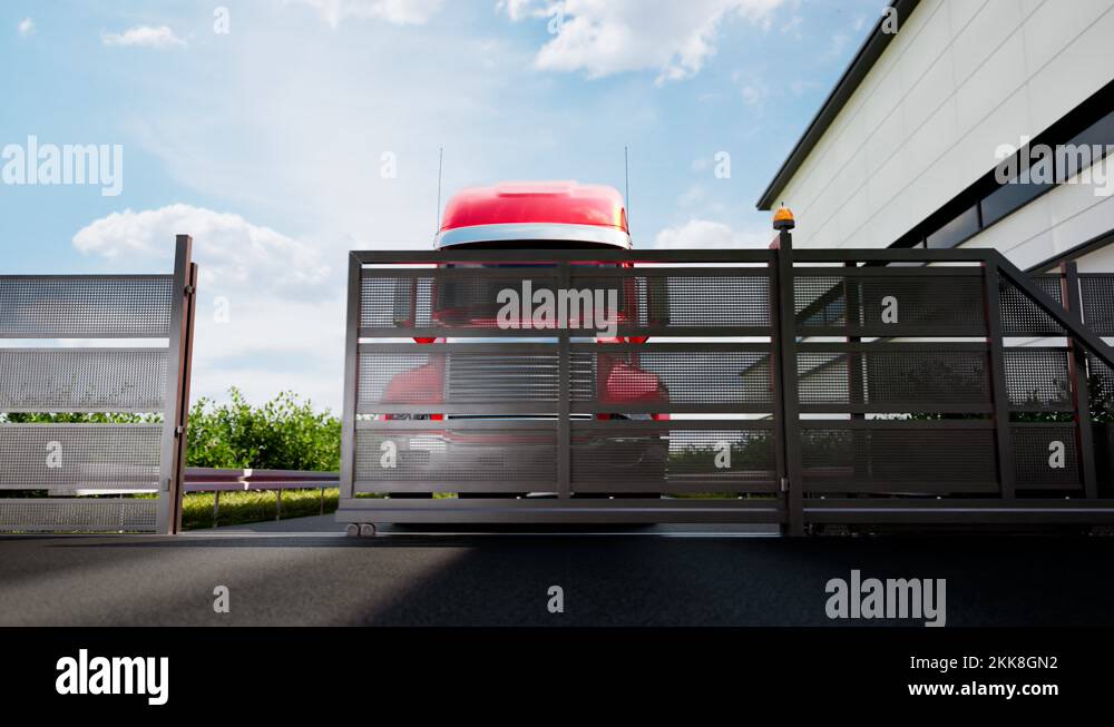 Red truck with heavy cargo. The gate opens and a giant lorry leaves the ...