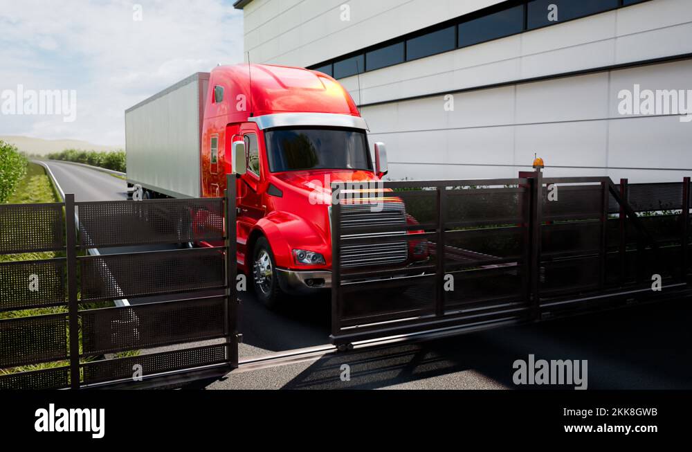 Red truck with heavy cargo. The gate opens and a giant lorry entering ...