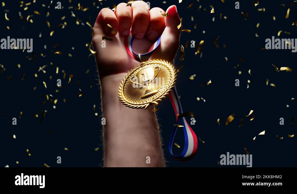 Rising hand holding a shiny gold medal. Top winner with first prize ...