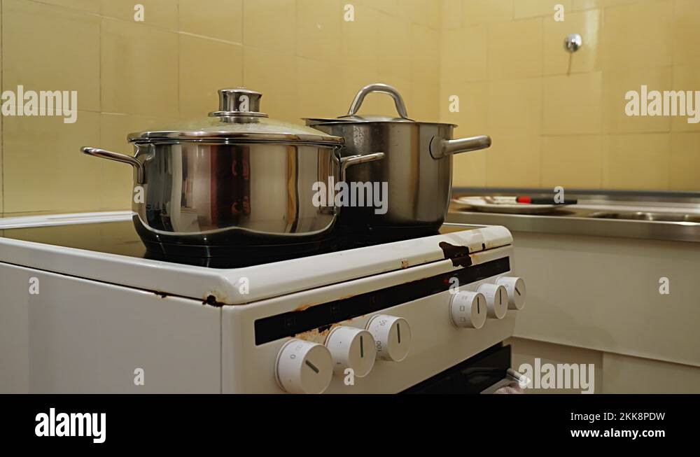 Two pots that are cooking on a hotplate where a water bubble comes out ...