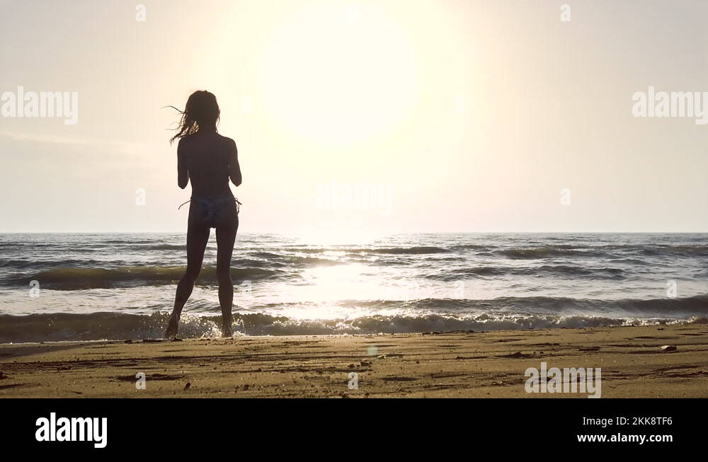 Girl In A Bikini On A Beach At Sunset Jumping Exercising Slowmotion 2226