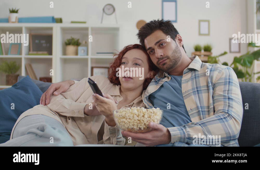 Romantic Couple Cuddling and Eating Popcorn Stock Video Footage - Alamy