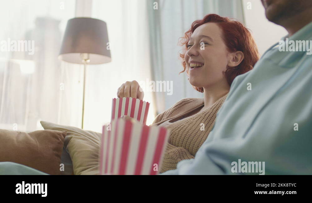 Woman Eating Popcorn Laughing Stock Video Footage - Alamy