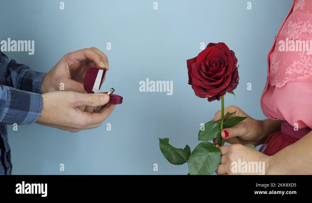 Man is making a proposal to woman, close up. Male hand is holding ...