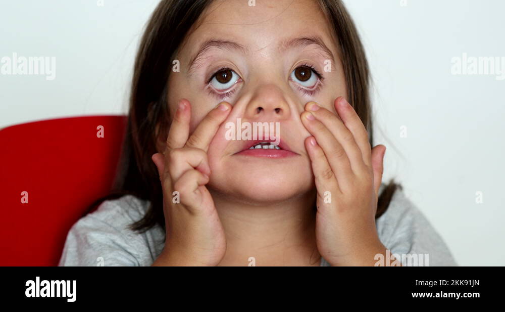 Little girl grimacing, sticking ongue out. Child grimace making funny ...