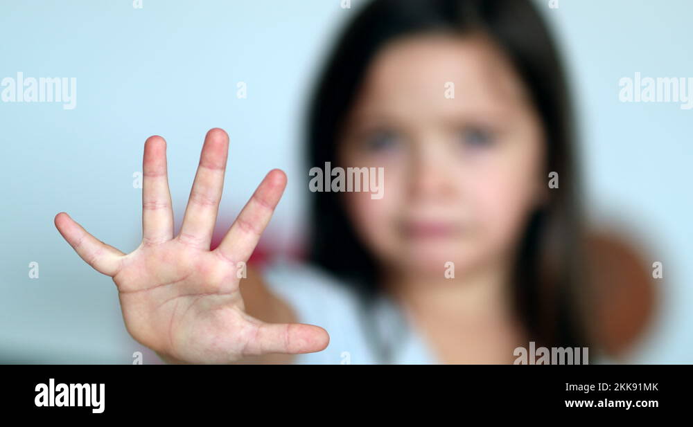 Little girl stop sign with hand, saying no, expressing defense or ...