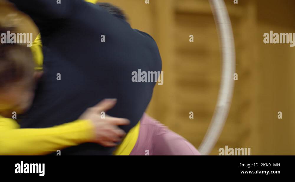 Two athletes are training, spinning on a hoop, circus artists ...