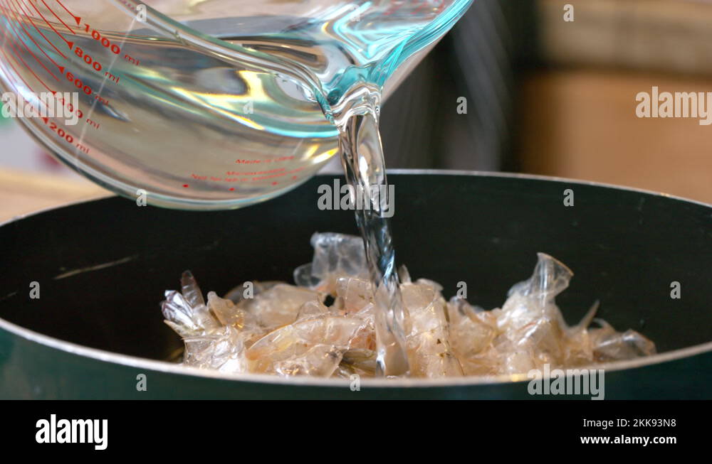 Pouring water over shrimp shells to render seafood stock for gumbo ...