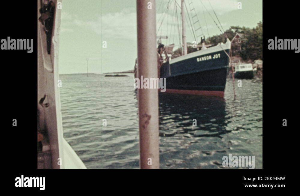 1970s: Man steers boat. Man pulls up lobster trap Stock Video Footage ...