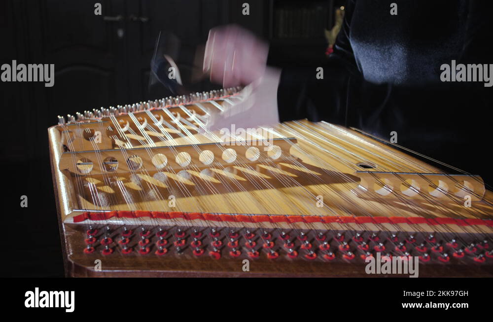 Playing traditional musical instruments. Close-up of hummered dulcimer ...