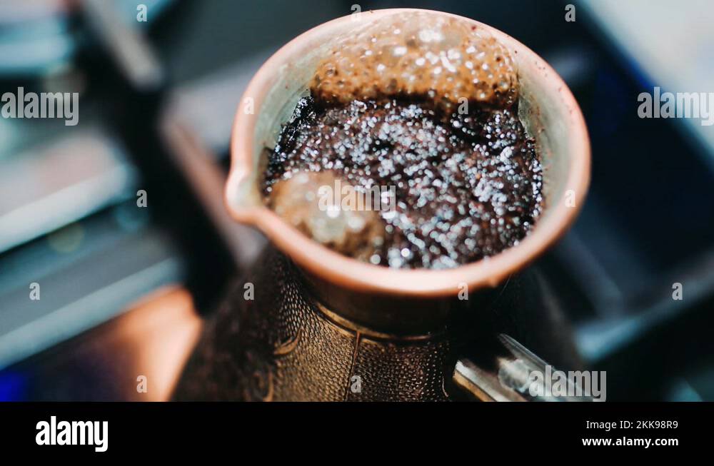 brewing traditional black Turkish coffee in a cezve on the stove Stock ...