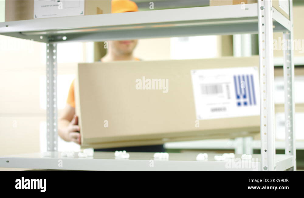 Warehouse worker puts carton goods Stock Videos & Footage - HD and 4K ...