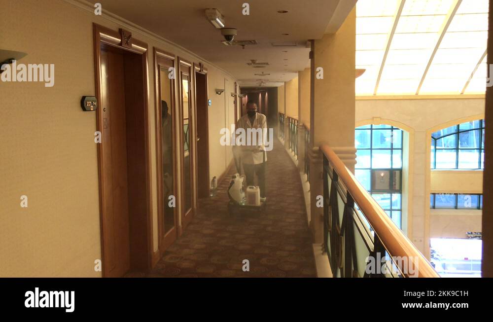 Janitor Disinfecting hotel room corridors to Avoid The Spread Of Stock ...