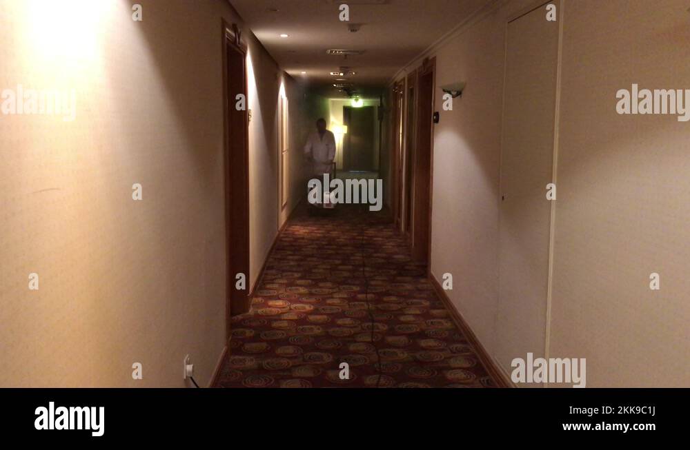 Janitor Disinfecting hotel room corridors to Avoid The Spread Of Stock ...