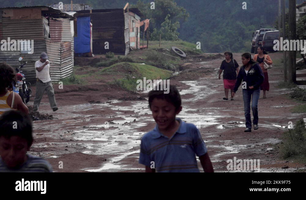 Poor people walking on a dirt road in a slum of Guatemala City Stock ...