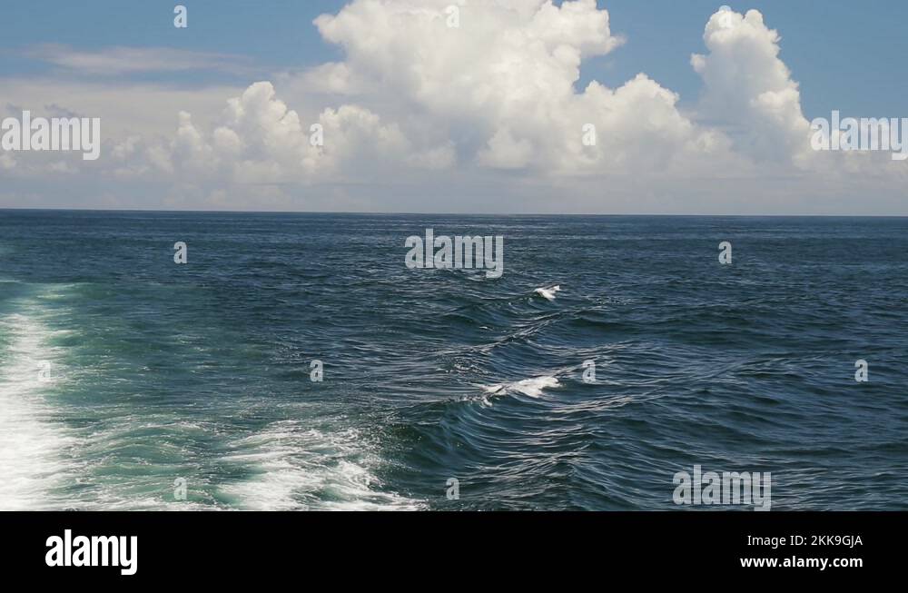 A shot of a wake left behind a catamaran. Filmed from a Catamaran with ...