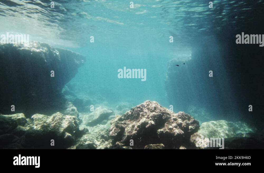 Action camera footage swimming underwater emerging inside a cave Stock ...