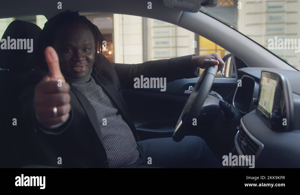 Excited african american black man showing thumb up while sitting on ...