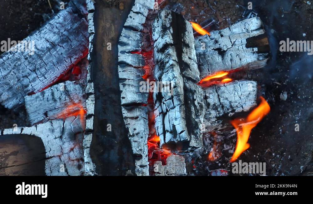 texture of burning lights and fire in a bonfire. Burning logs close-up ...