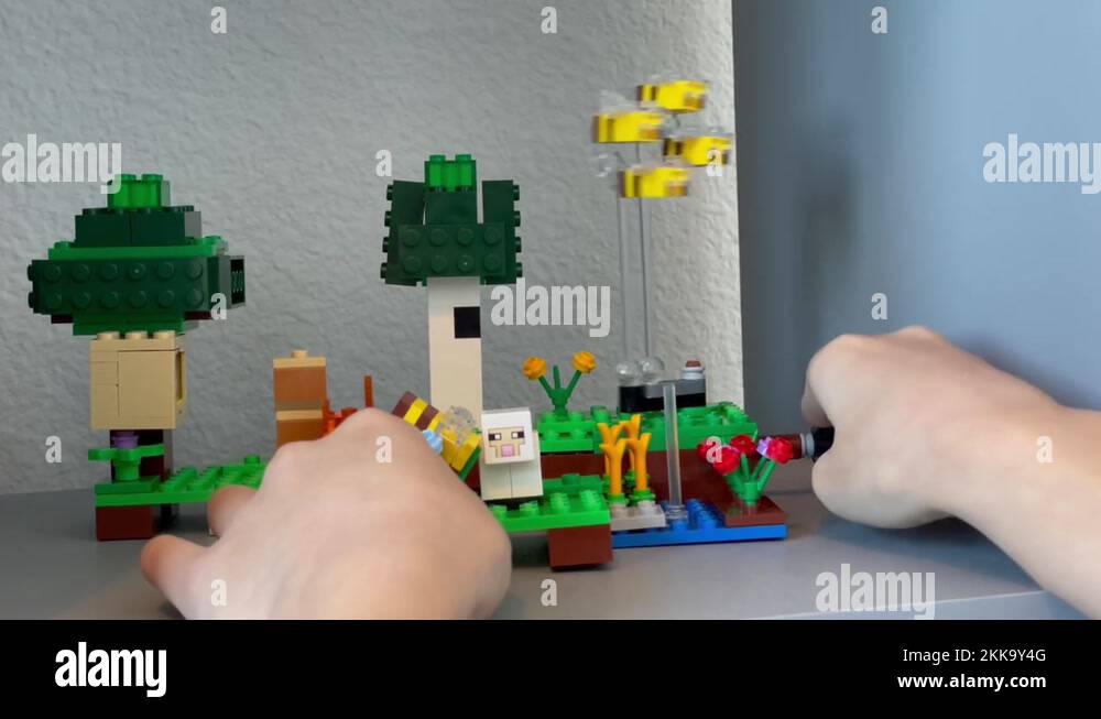 Small hands playing with the LEGO MINECRAFT BEE FARM building set Stock ...