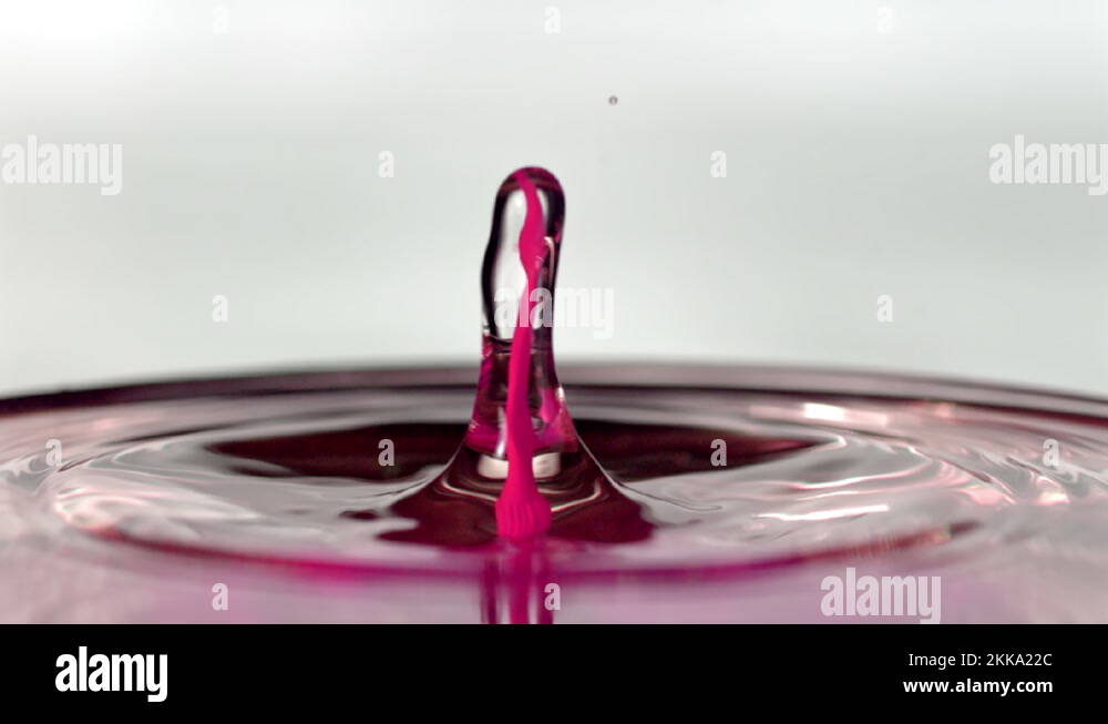 Pink droplet of paint splashing into liquid and bouncing up Stock Video ...