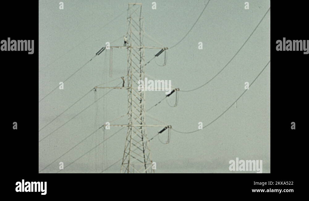1970s: Box of small spools of wire. Telephone lines. Men work on towers ...