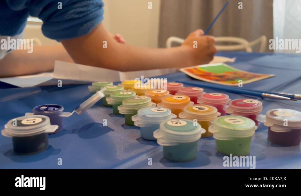 PAINT BY NUMBER - Child using a "Color by Number" art technique to ...