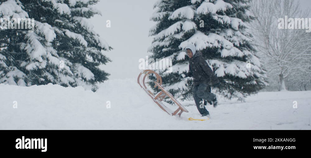 African American Black kid boy having a snowbrawl, jumping and throwing ...