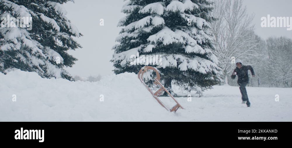 African American Black kid boy having a snowbrawl, jumping and throwing ...