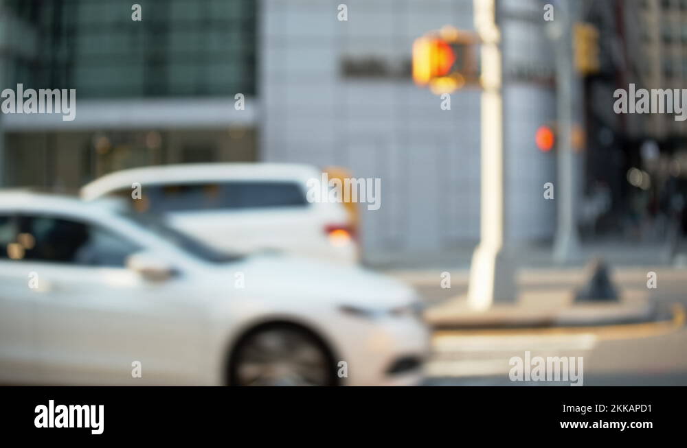 New York City street, traffic lights, blurry driving cars passing ...
