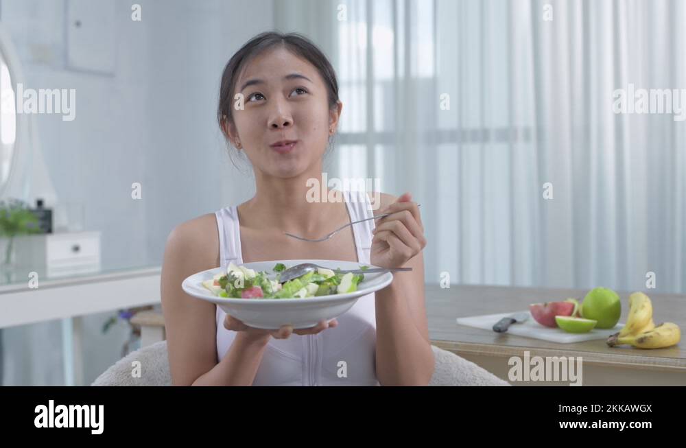 Health concept of 4k Resolution. Asian girls happily eating vegetable ...