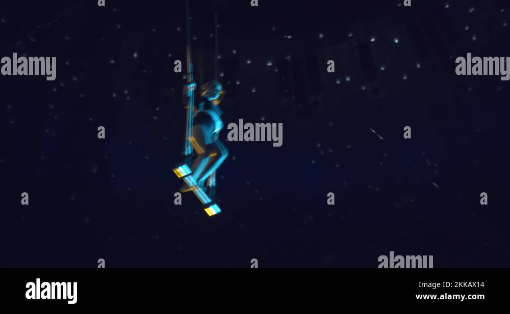 Female acrobat is performing at the circus, swinging on a swing high up ...