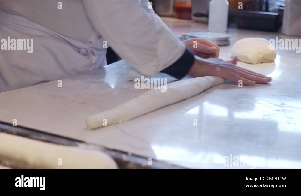 Chef forming bread dough on cooking table in the restaurant. Hands ...
