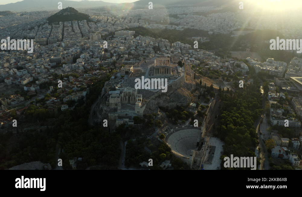 Drone shot above the Acropolis moving backwards, revealing the city of ...