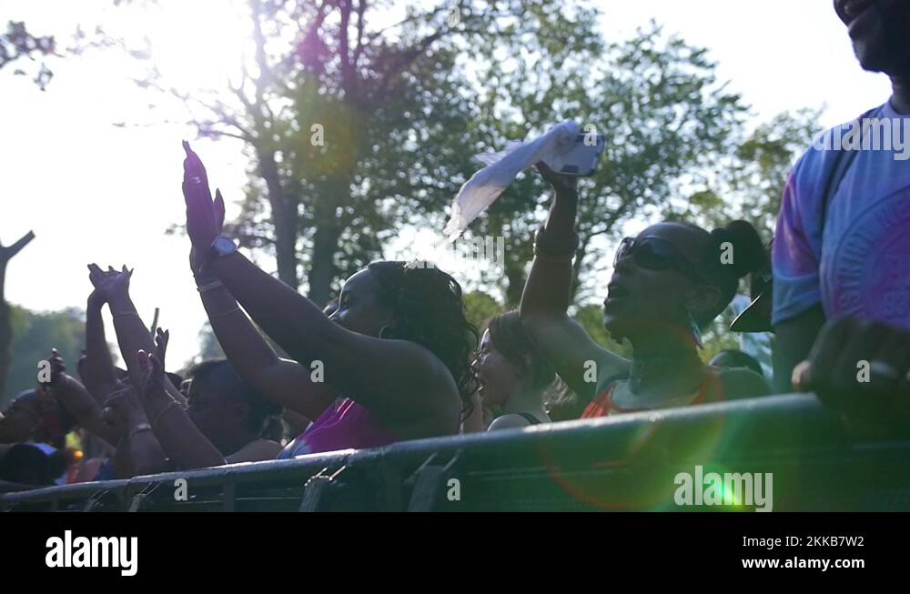 A crowd of people dancing at a music festival in summer, at the Leeds ...