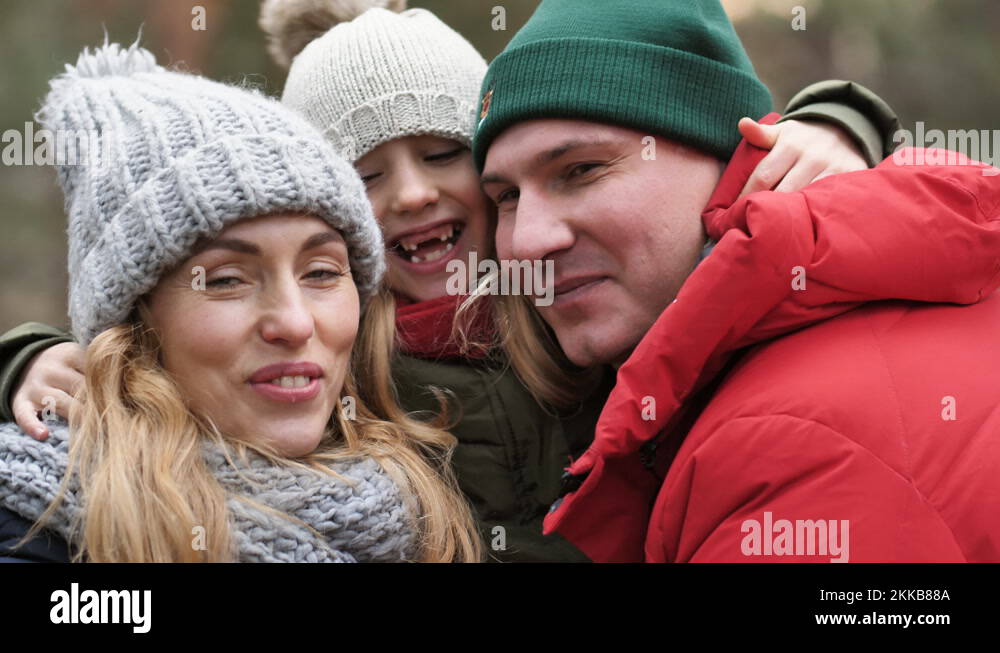 close-up beautiful married couple with a child are having fun, hugging ...