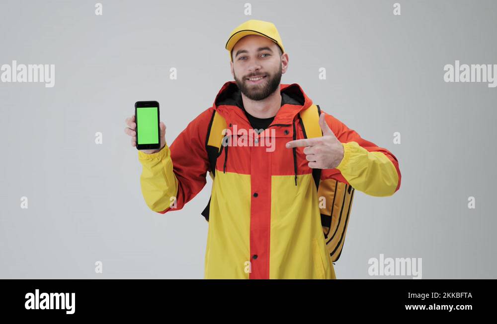 Courier showing his smartphone green screen chroma key pointing finger ...