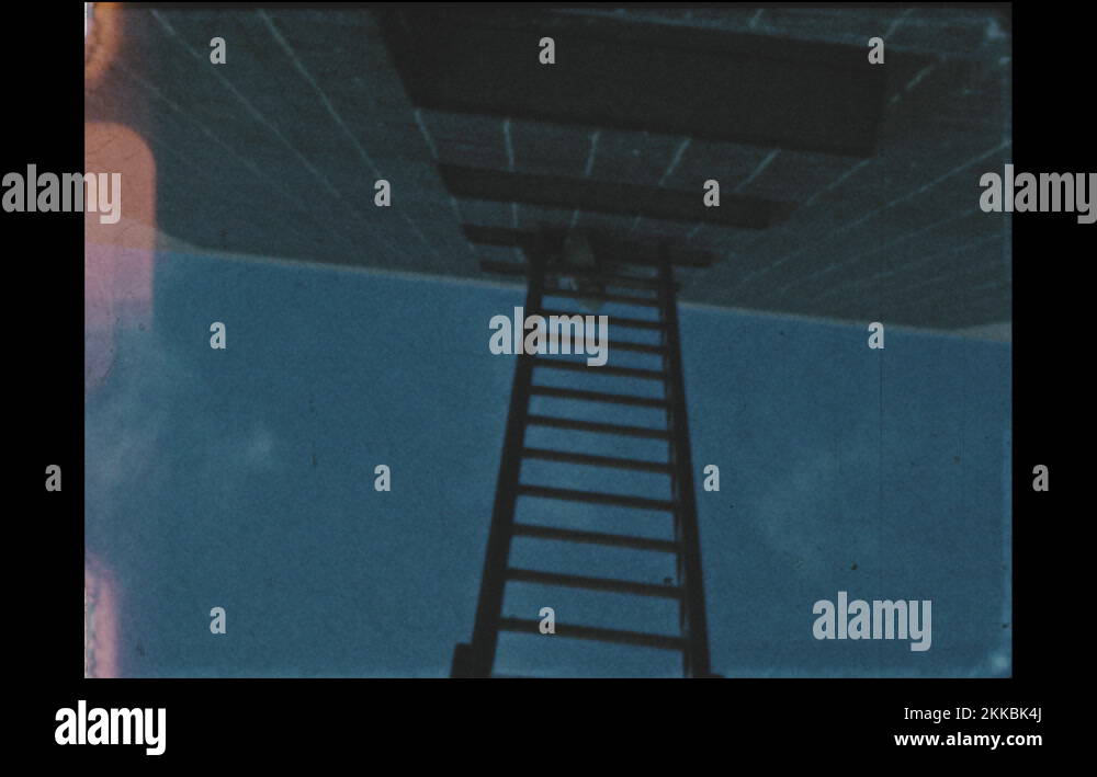 1960s: Low angle shots, man climbing ladder. Shots of men climbing ...