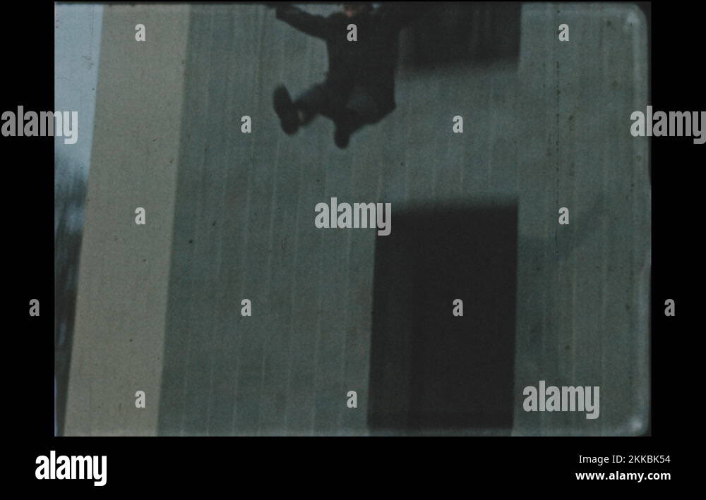 1960s: Shots of men jumping out of building into safety net Stock Video ...