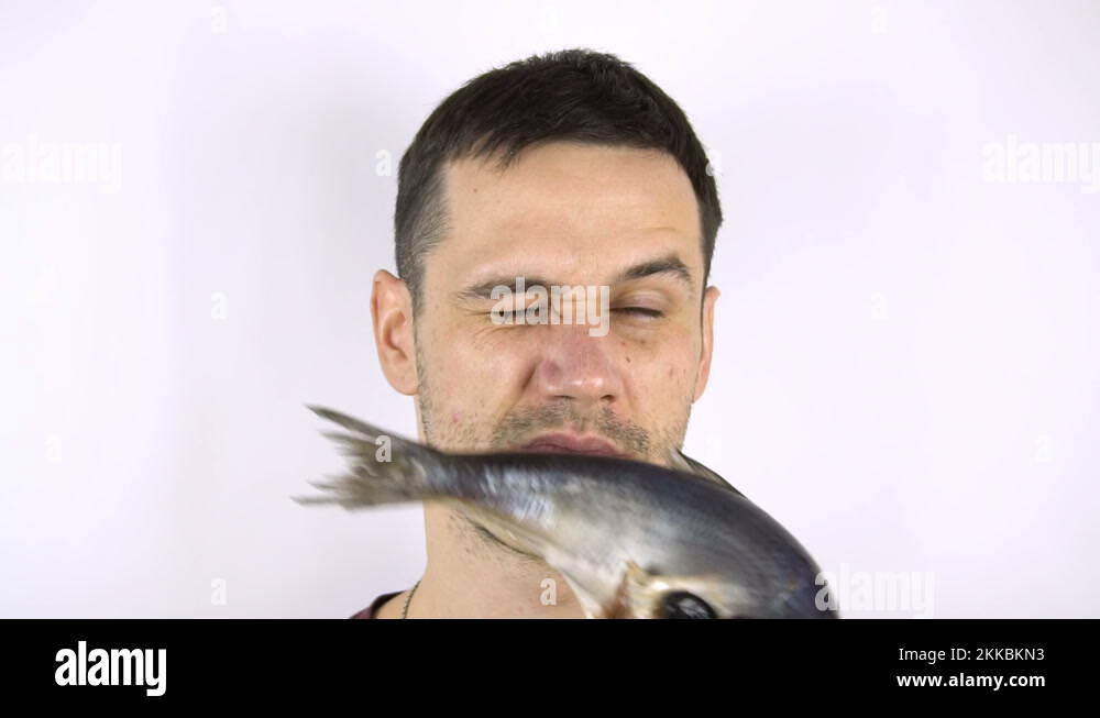 Funny young guy is slapped in the face with wet fresh fish Stock Video ...