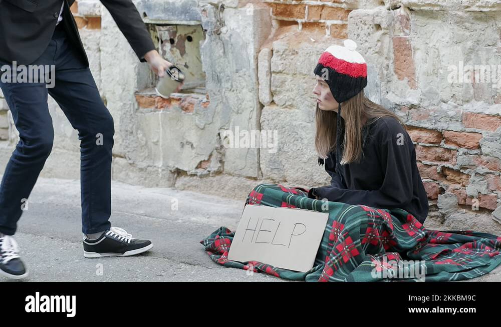 A kindhearted young man offers a cup of coffee to a homeless girl ...