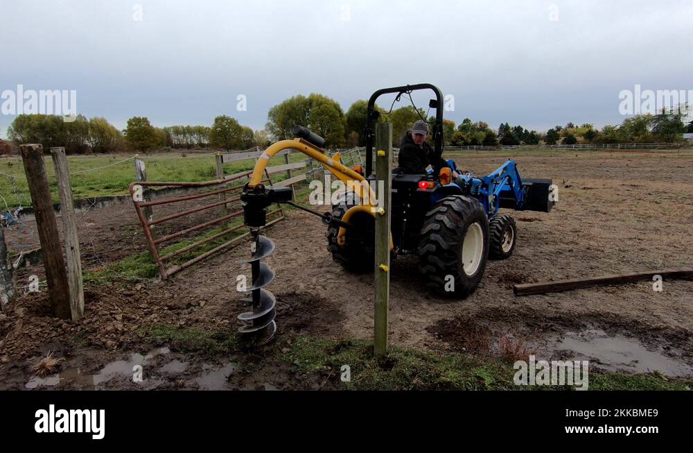 Man Operate Hydraulic Post Hole Auger Mounted On Tractor Digging On ...