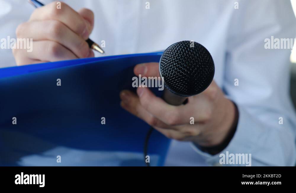 Correspondent or journalist interviewing and writing something down in ...