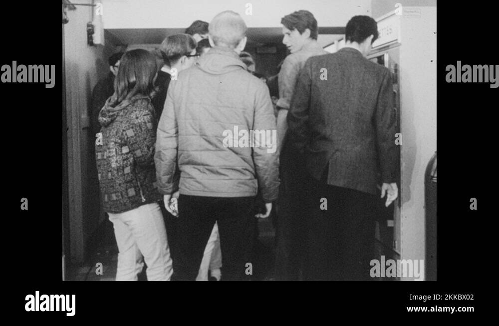 1960s: People crowd around vending machine. Crowd walks into cafeteria ...